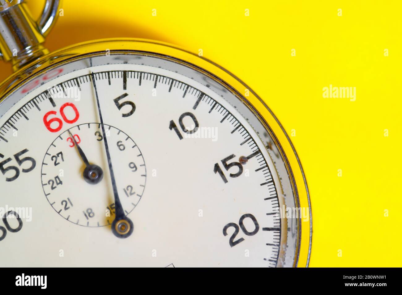 Classic stopwatch on a yellow background Stock Photo - Alamy