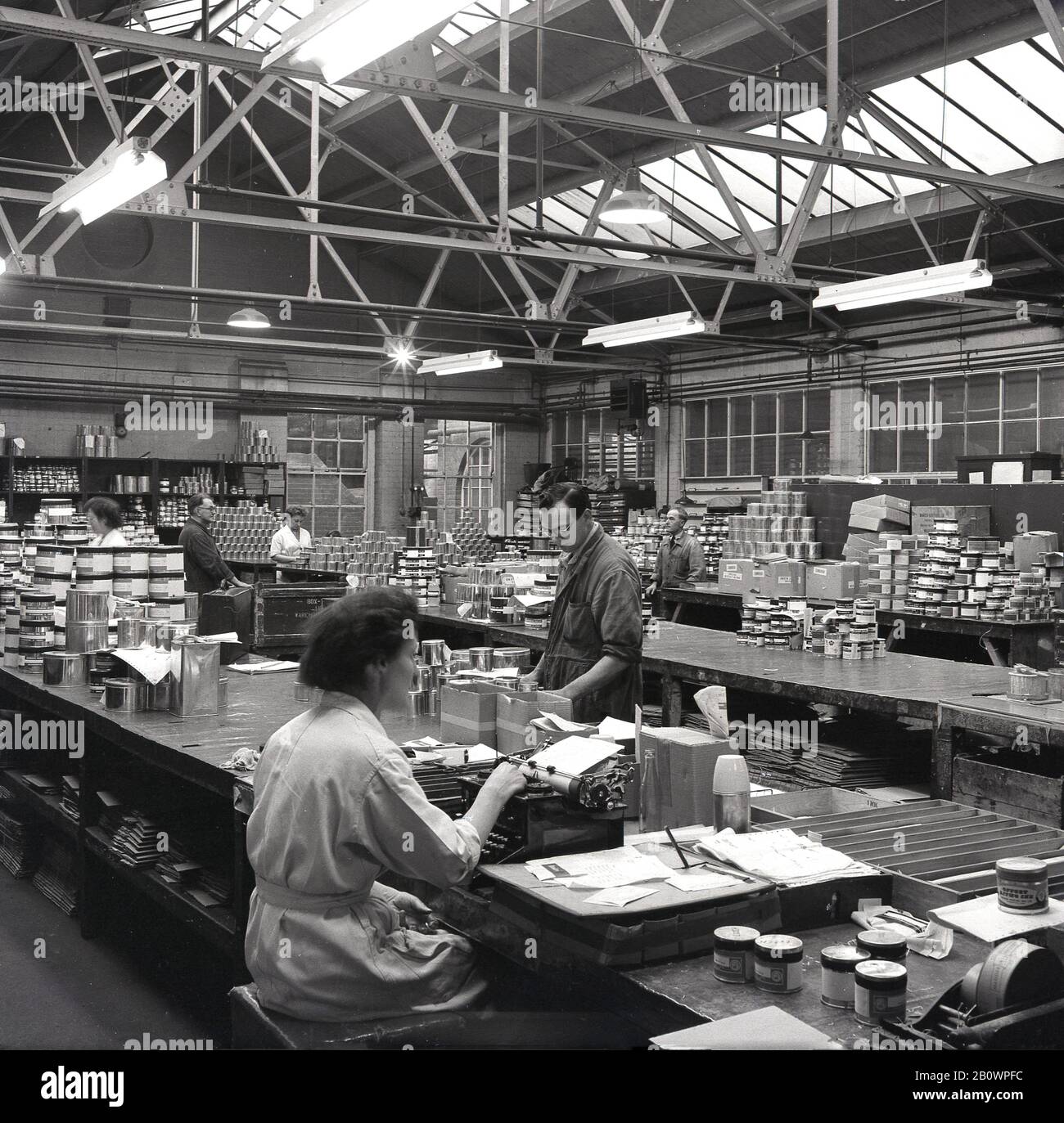 1950s, historical, at a paint factory, male and female workers in a ...