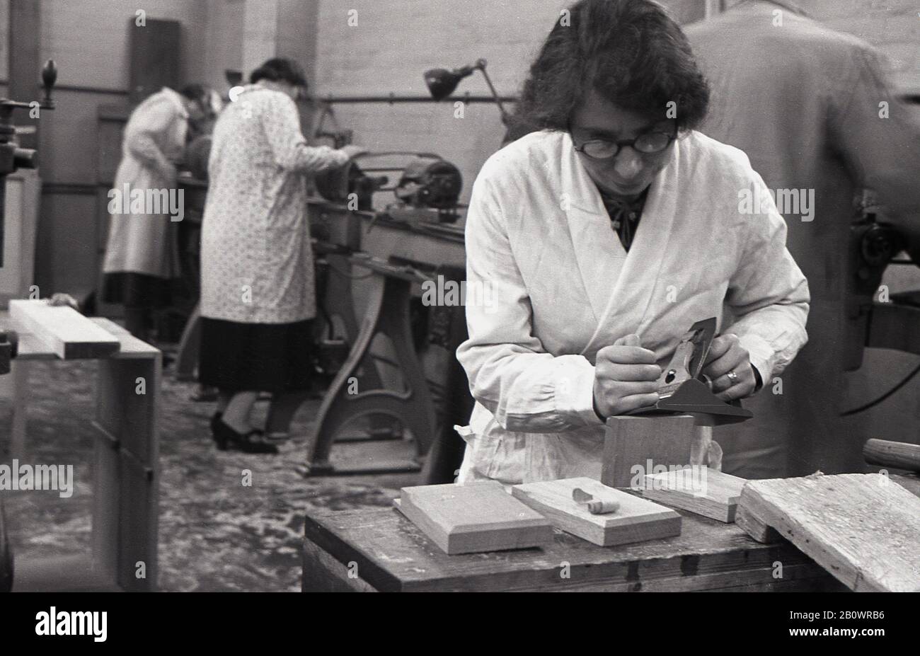 1940s, historical, mature ladies in a woodworking class, at night ...