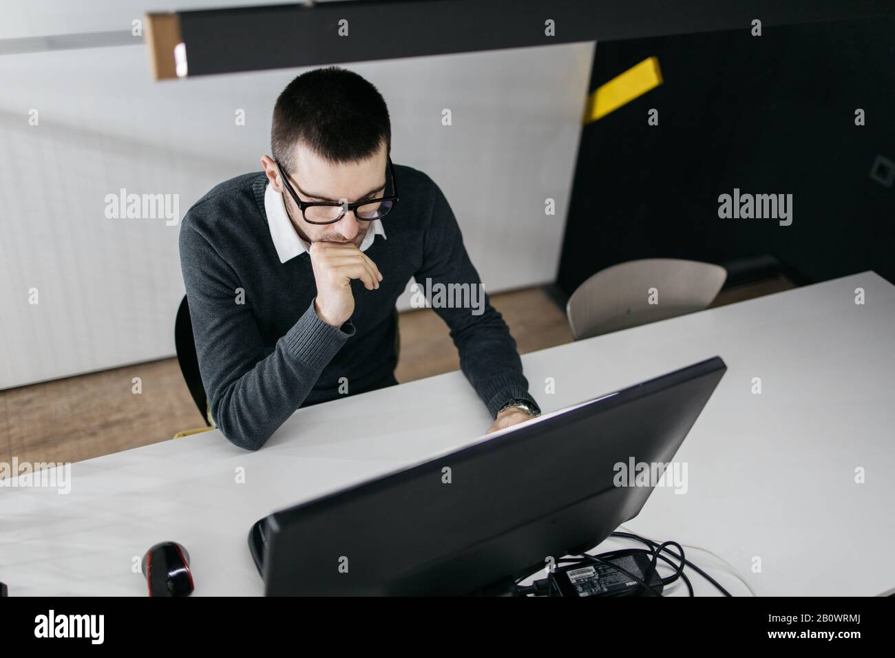 Top view of a man working on computer. Office worker reading articles ...