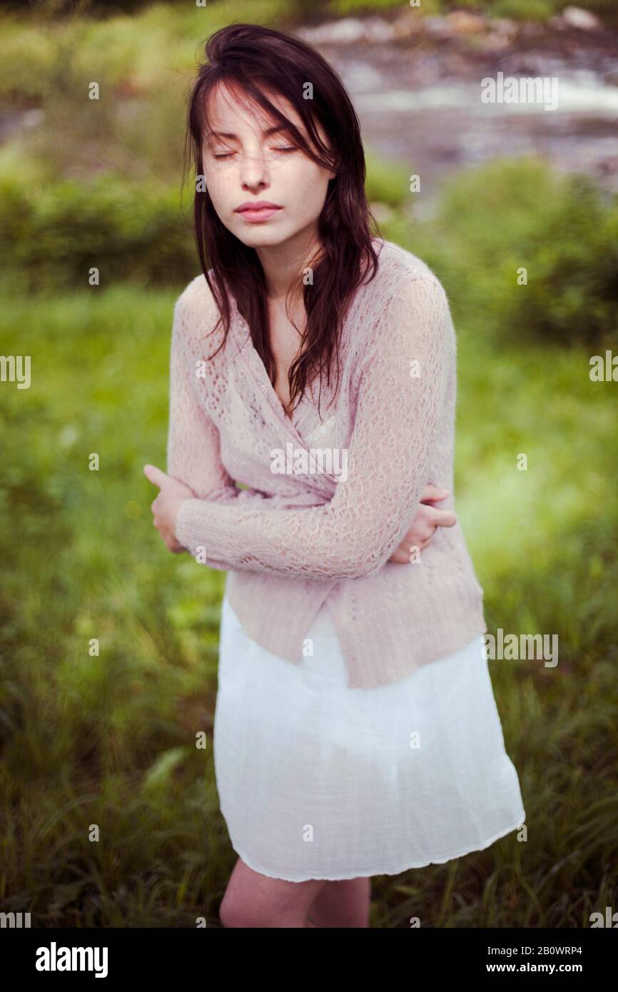 Young woman with crossed arms and closed eyes Stock Photo - Alamy