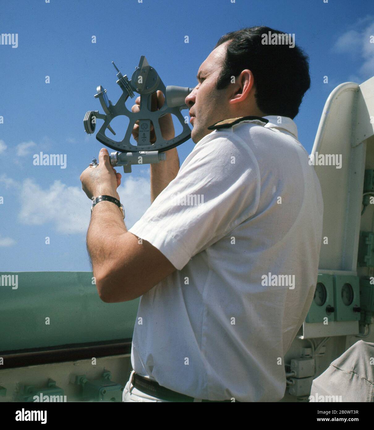 1960s, historical, ship's navigator outside on deck using a sextant, a ...