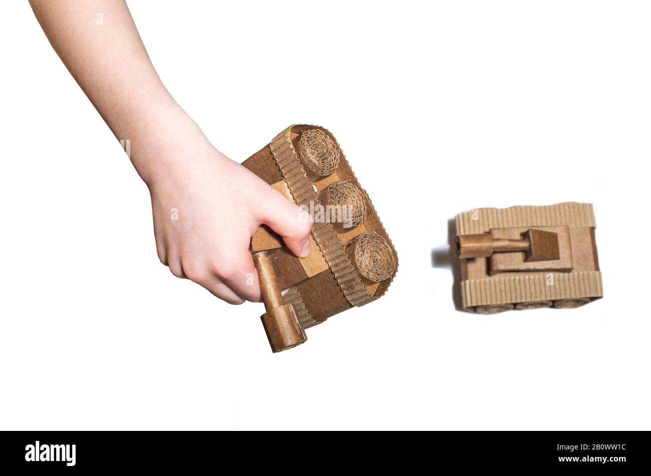 children's hands play with tanks. two toy tanks made by children from ...