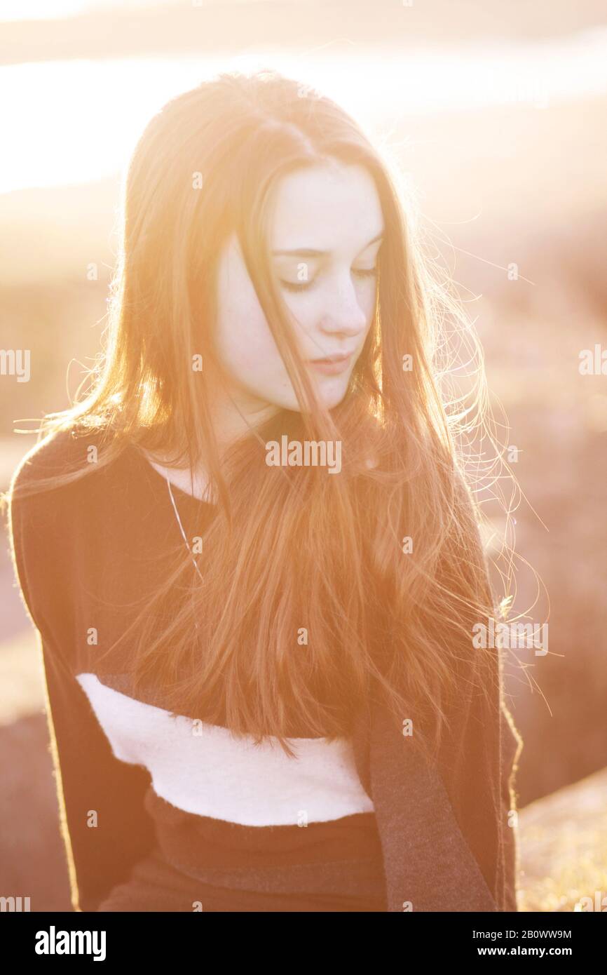 Portrait of a young woman against the light Stock Photo - Alamy