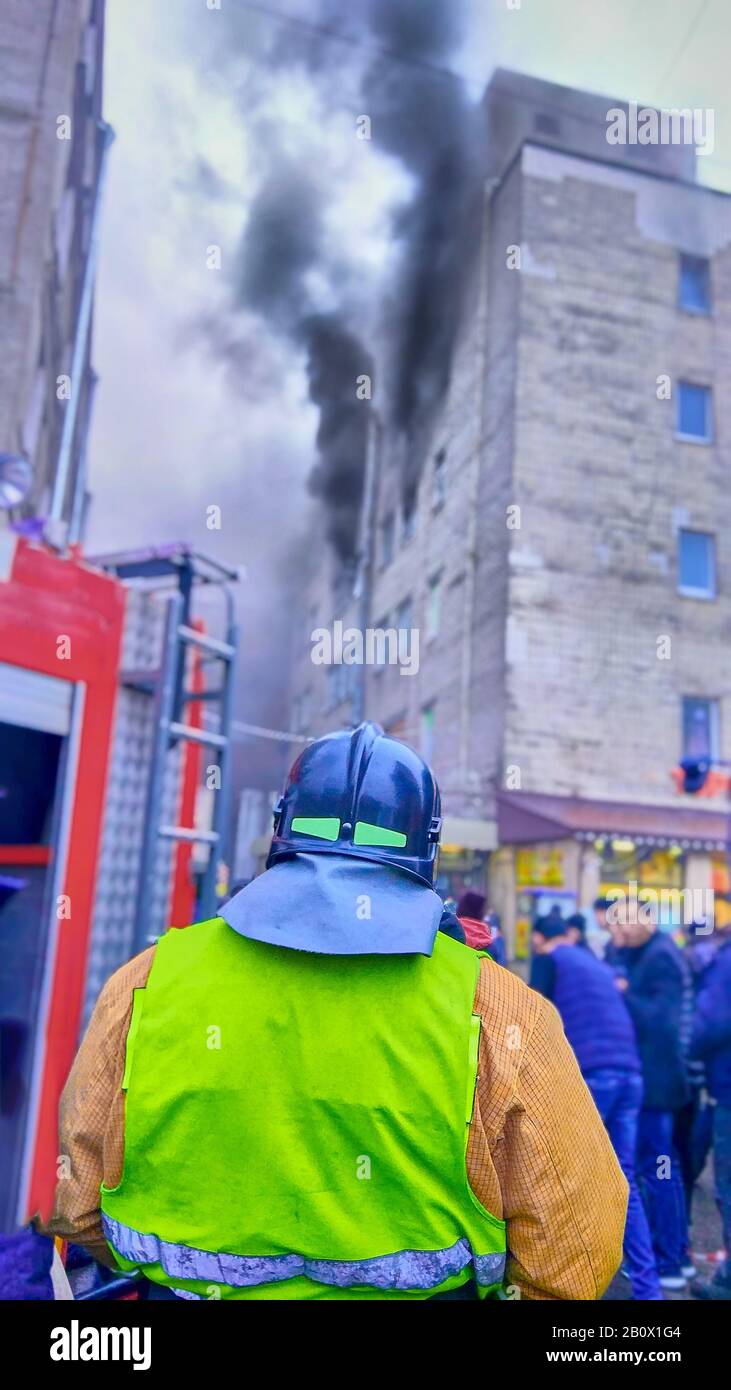 firefighter in front of a fire in a high-rise trade building, fighting ...