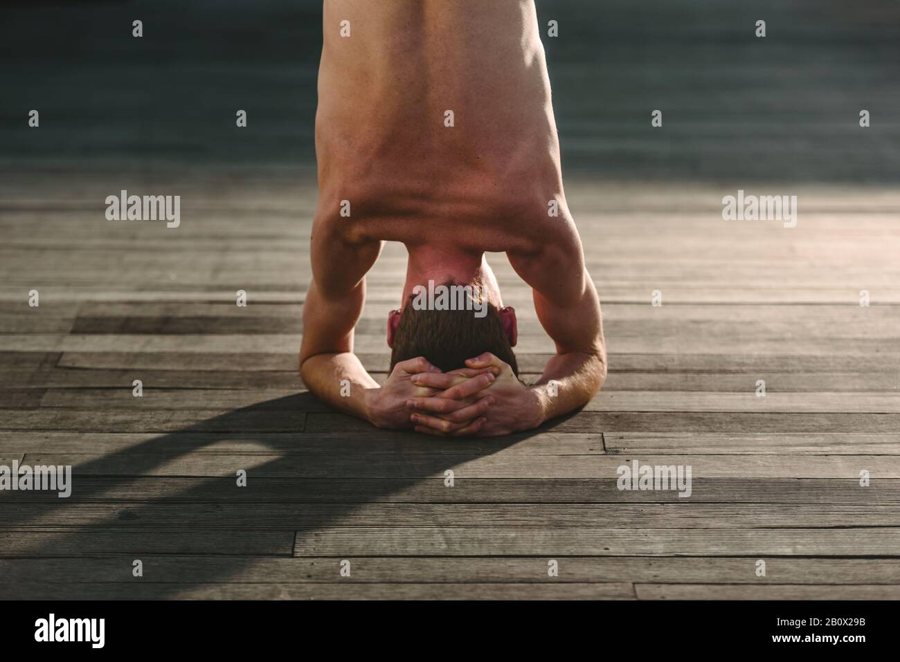 Yoga apprentice practicing sirsasana, inverted posture with the head ...