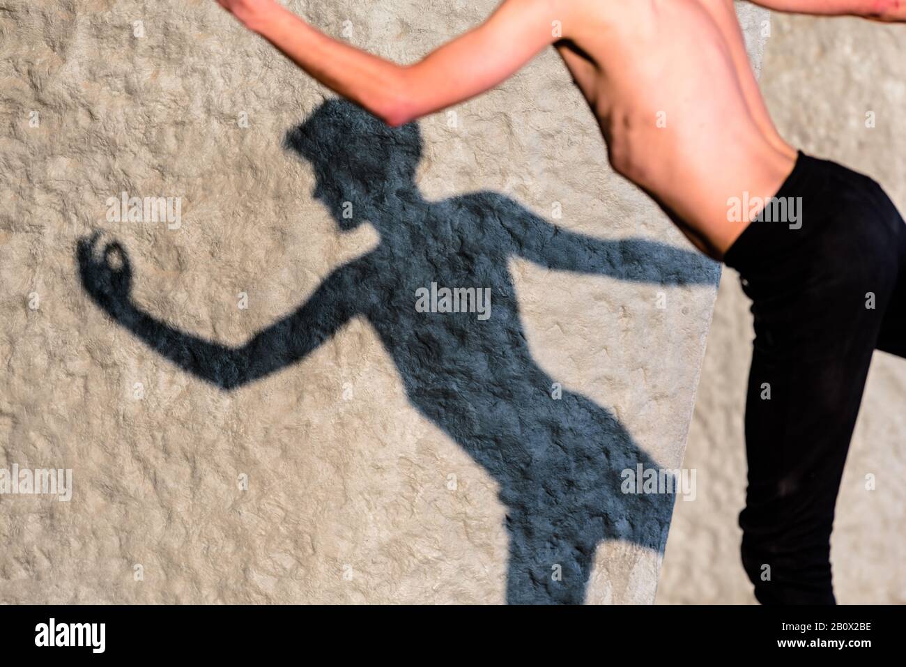 Shadow of the silhouette of a young man posing like a dance Stock Photo ...