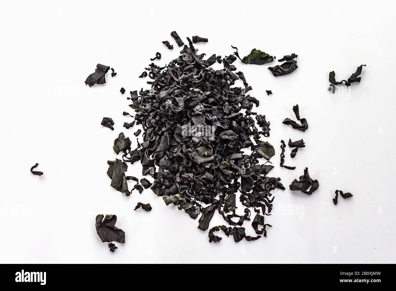 Dry wakame seaweed isolated on white background. Heap of dried kombu ...