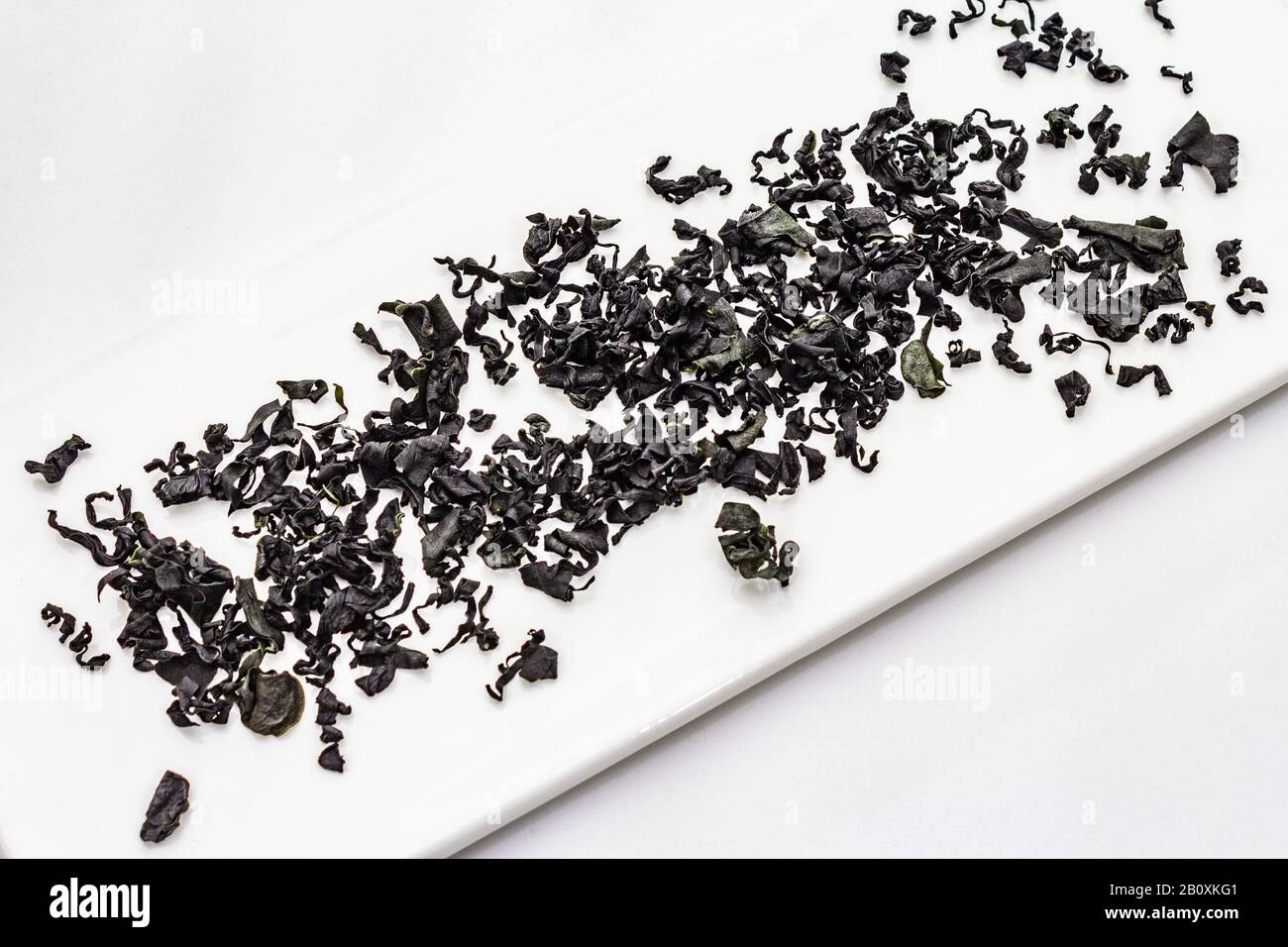 Dry wakame seaweed isolated on white background. Heap of dried kombu ...