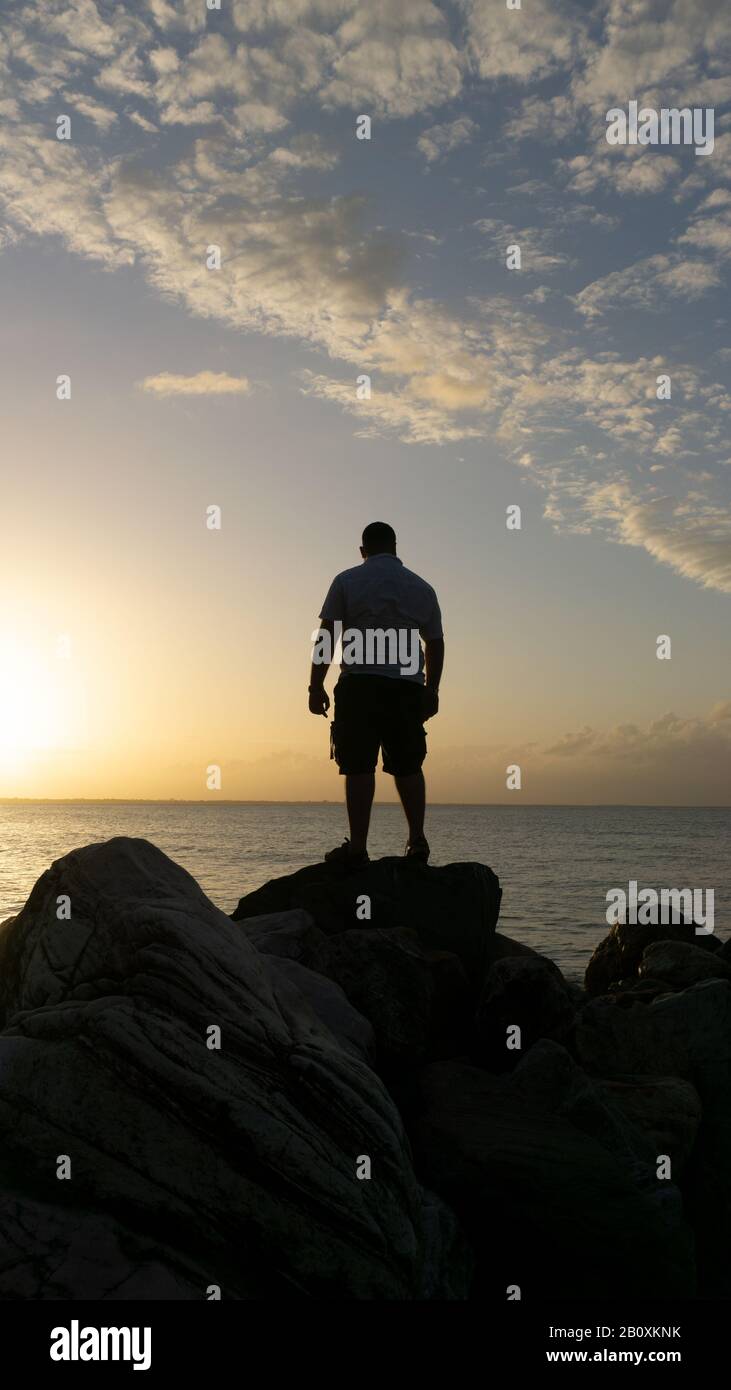 Sad man sitting on rocks hi-res stock photography and images - Alamy