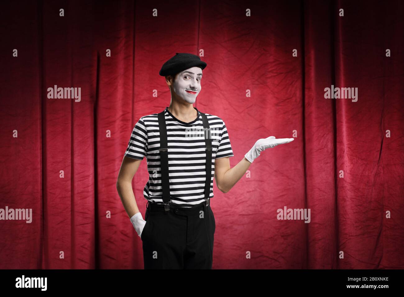 Mime performing a show on stage with red curtains Stock Photo - Alamy