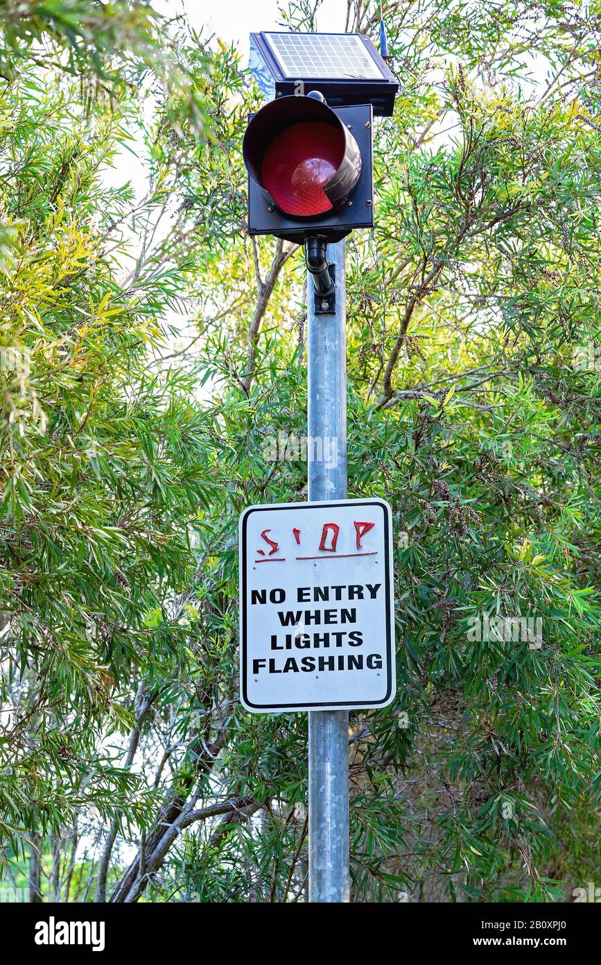 Stop no entry when lights flashing sign in bushland beside a helicopter ...