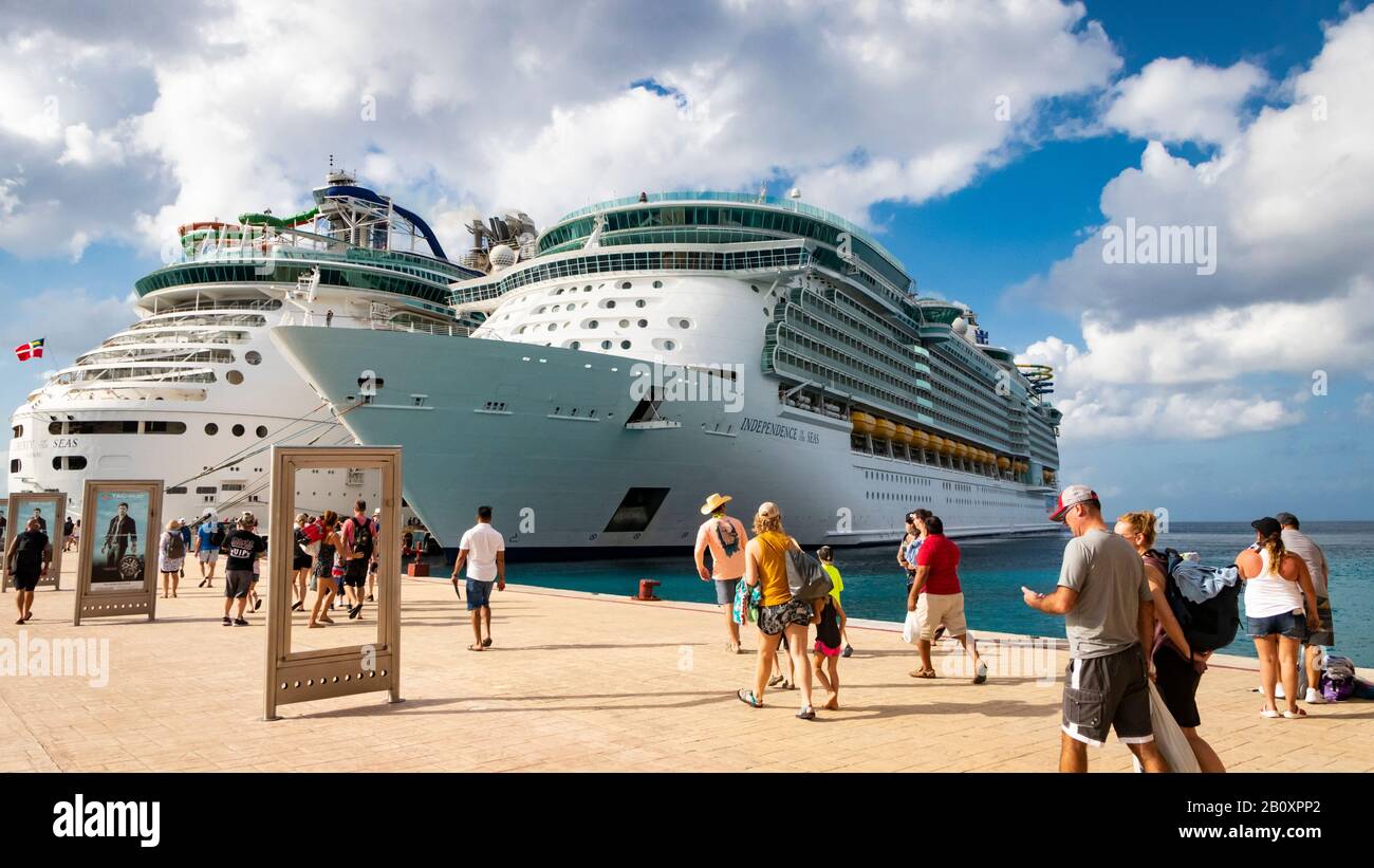 Tourists on vacation walk to and from their cruise ships at port ...