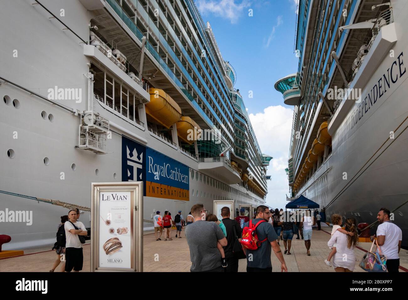 Tourists on vacation walk to and from their cruise ships at port ...