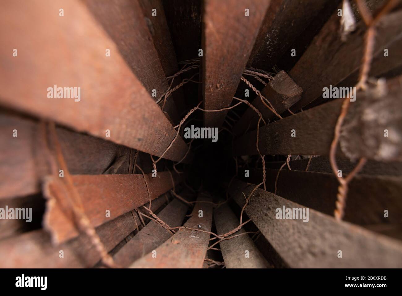 Looking through the rolled wooden fence Stock Photo - Alamy