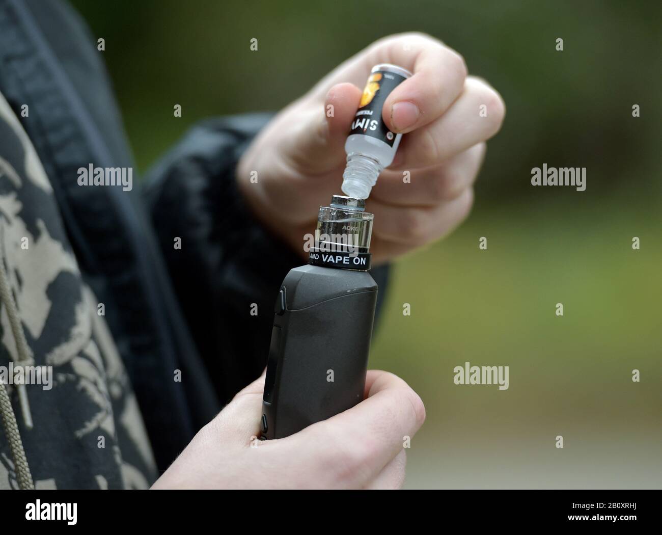 Stock photo vaping liquid being added to hi-res stock photography and ...