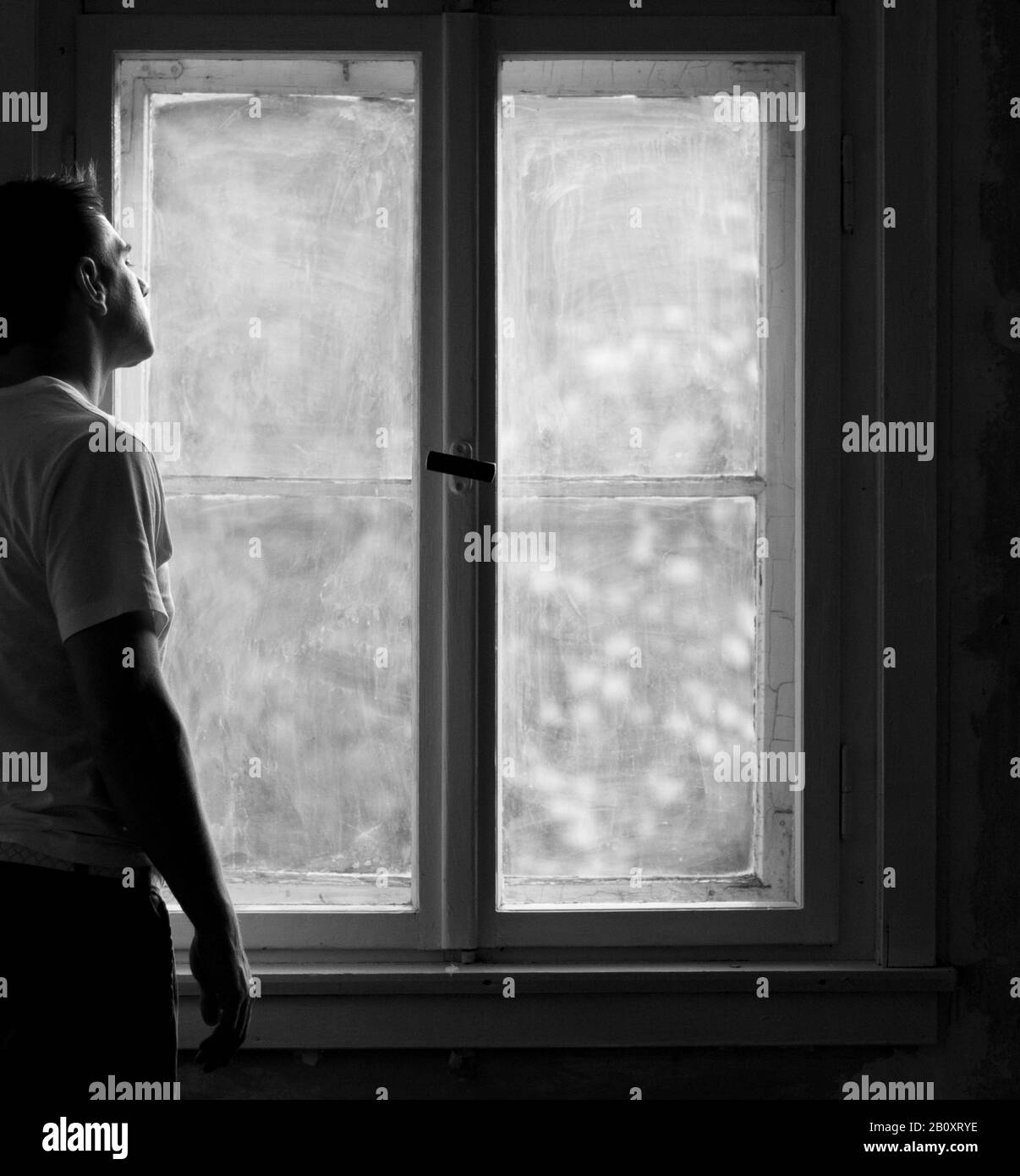Man looks from the window hi-res stock photography and images - Alamy