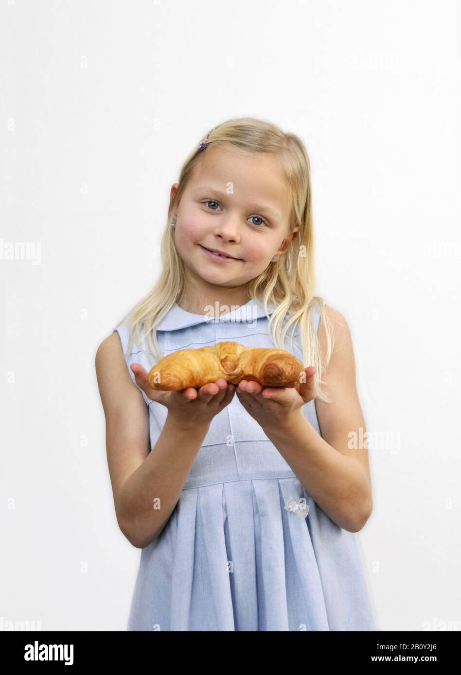 Little girl with croissant Stock Photo - Alamy