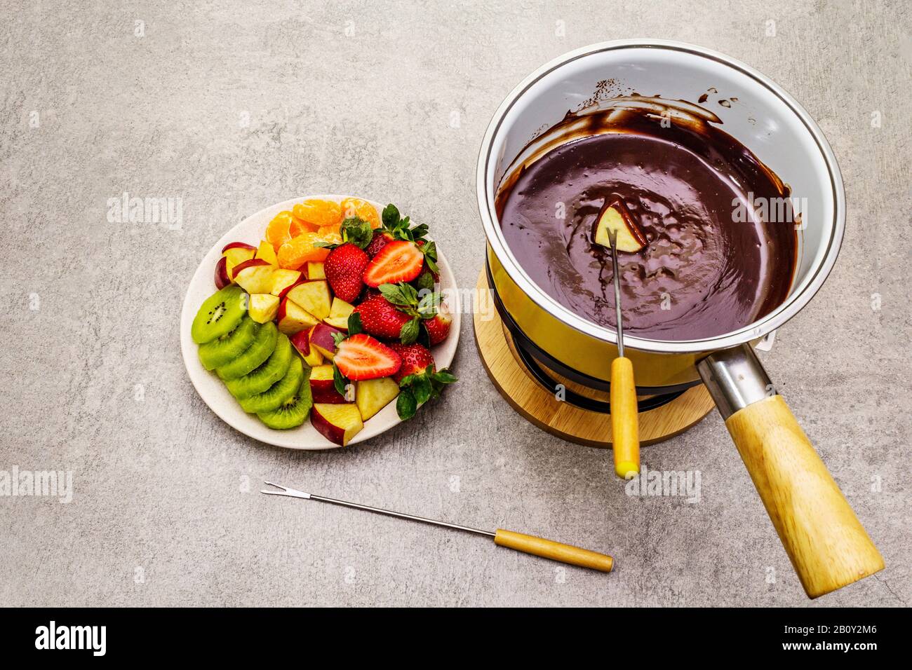 Chocolate fondue. Assorted fresh fruits, two types of chocolate ...