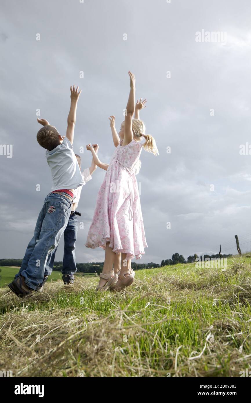 Children playing in a meadow Stock Photo - Alamy