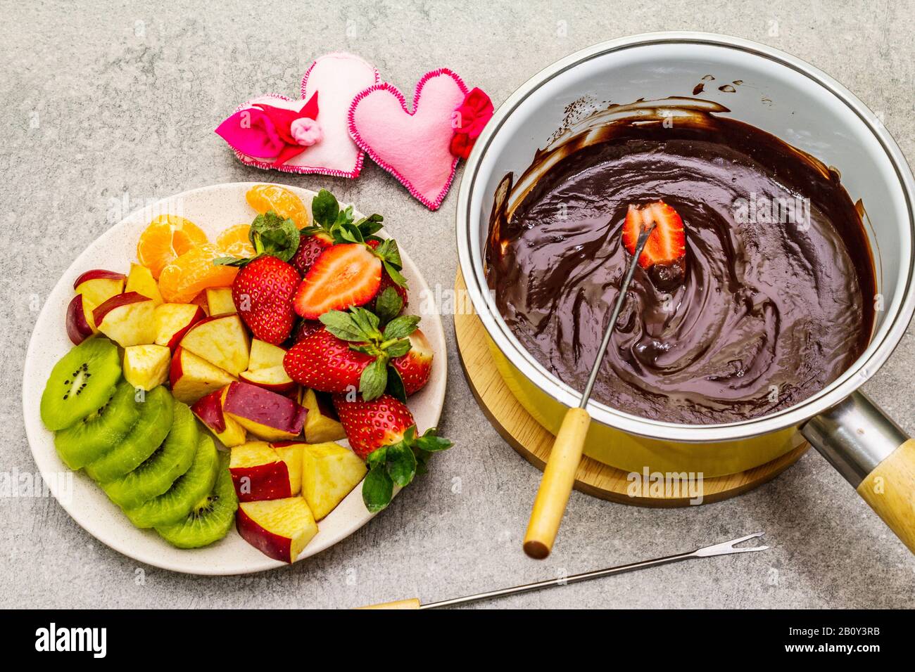 Chocolate fondue. Assorted fresh fruits, two types of chocolate, felt ...