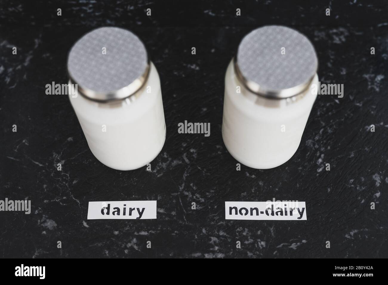 concept of switching to a vegan diet, bottles of milk with Dairy and ...