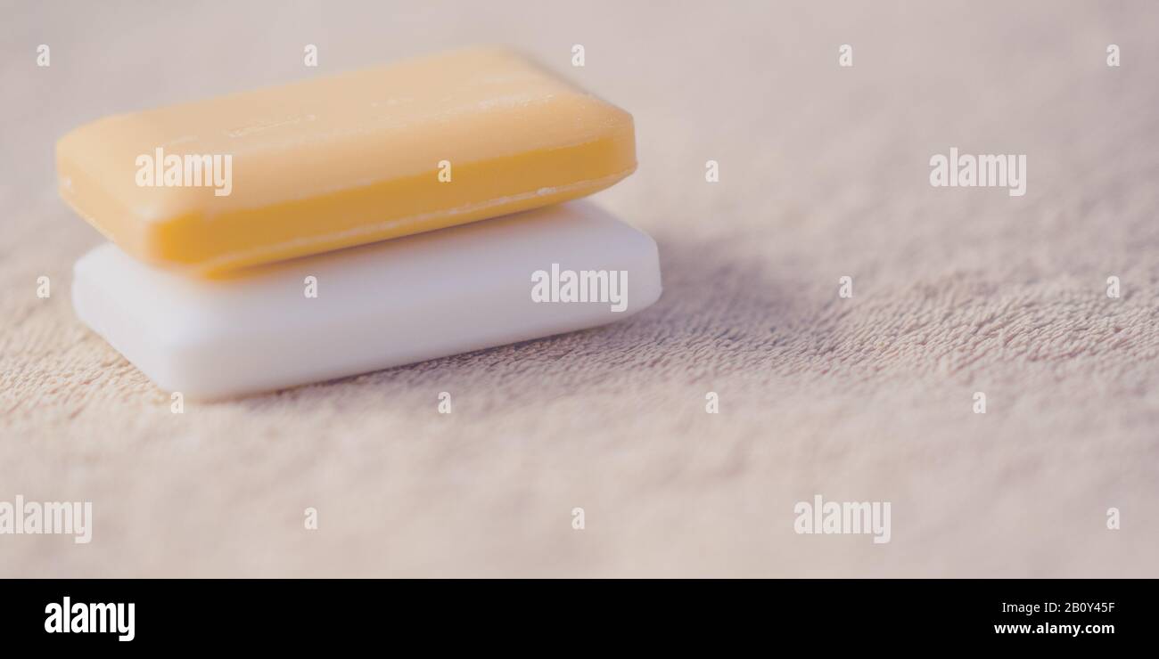 Two bars of soap on a brown towel. Side view Stock Photo - Alamy