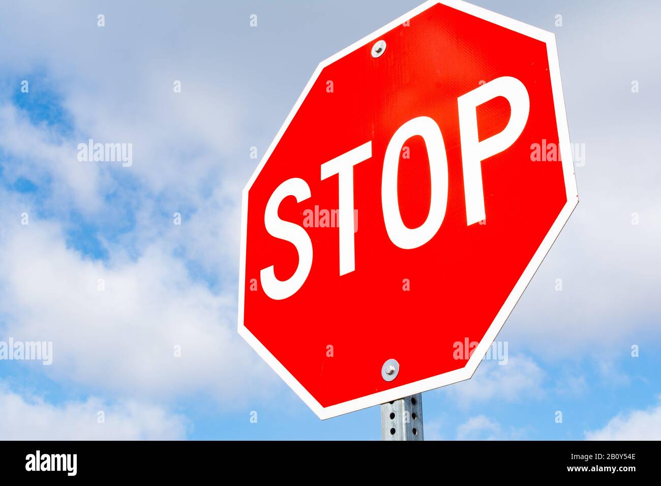 Stop sign with blue skies and clouds in the background Stock Photo - Alamy