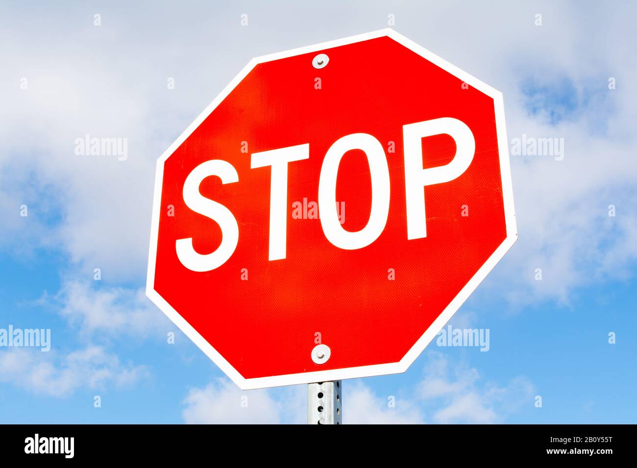 Stop sign with blue skies and clouds in the background Stock Photo - Alamy