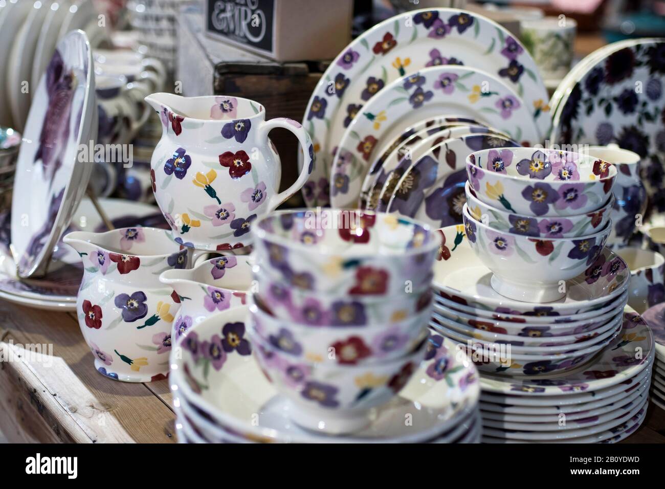 White ceramic plates on a shelf in a store. Designer ceramic plates ...