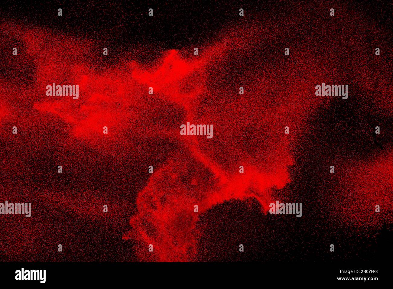 Red dust particles explosioon on black background.Red powder splash ...