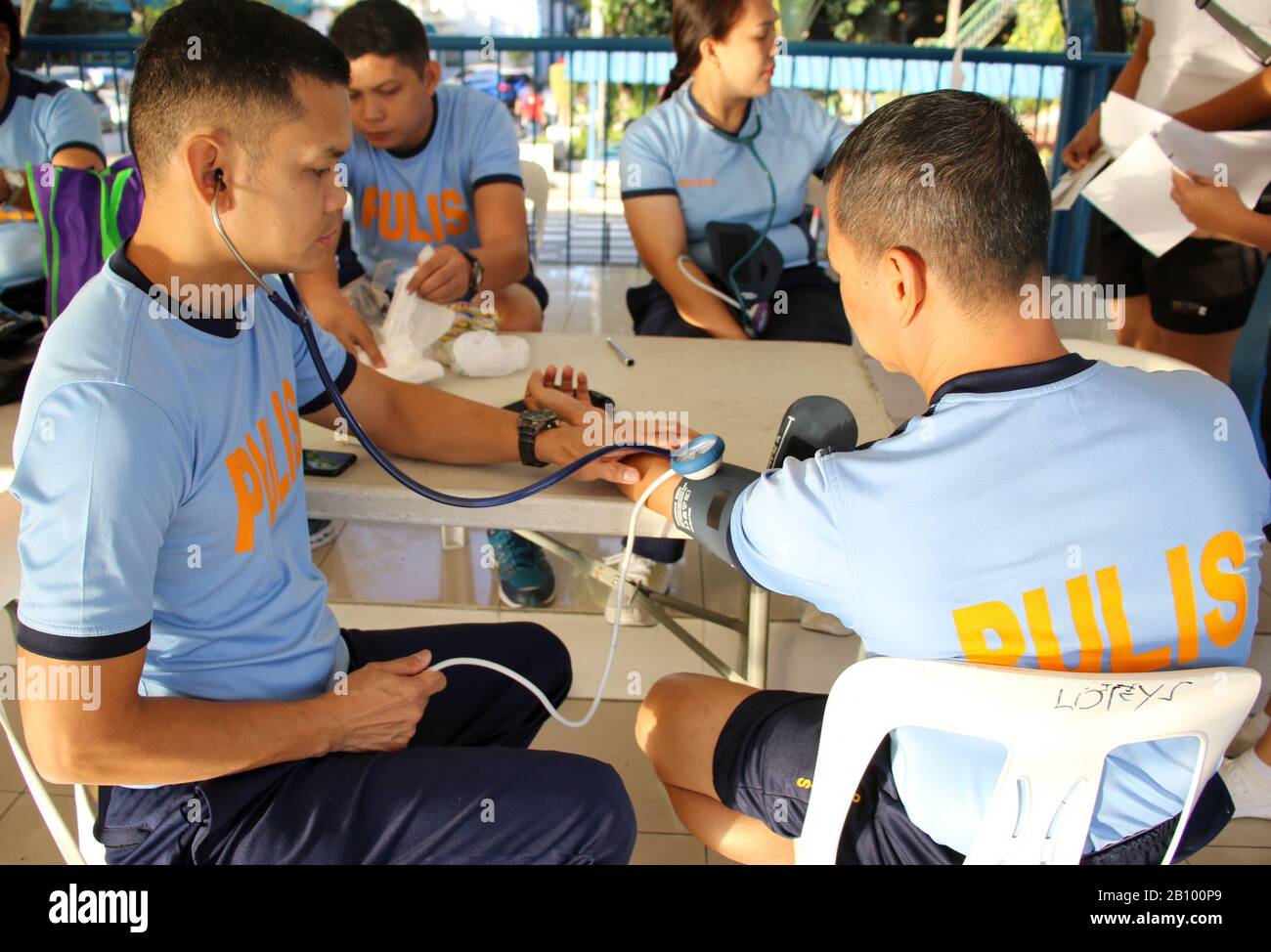 Quezon, Philippines. 20th Feb, 2020. Police nurse takes blood pressure ...