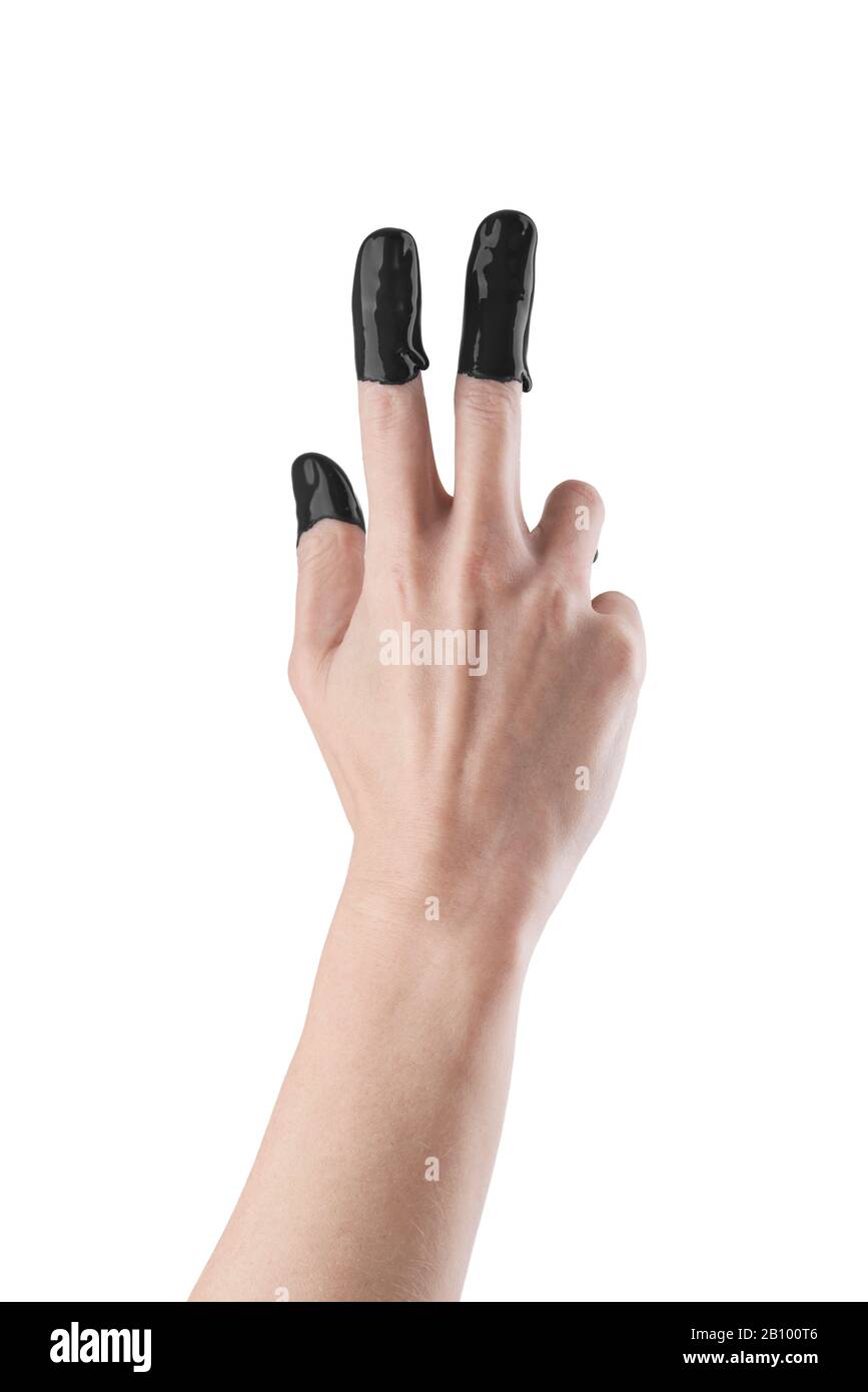 Female refined hand smeared with black and gold acrylic paint on a ...