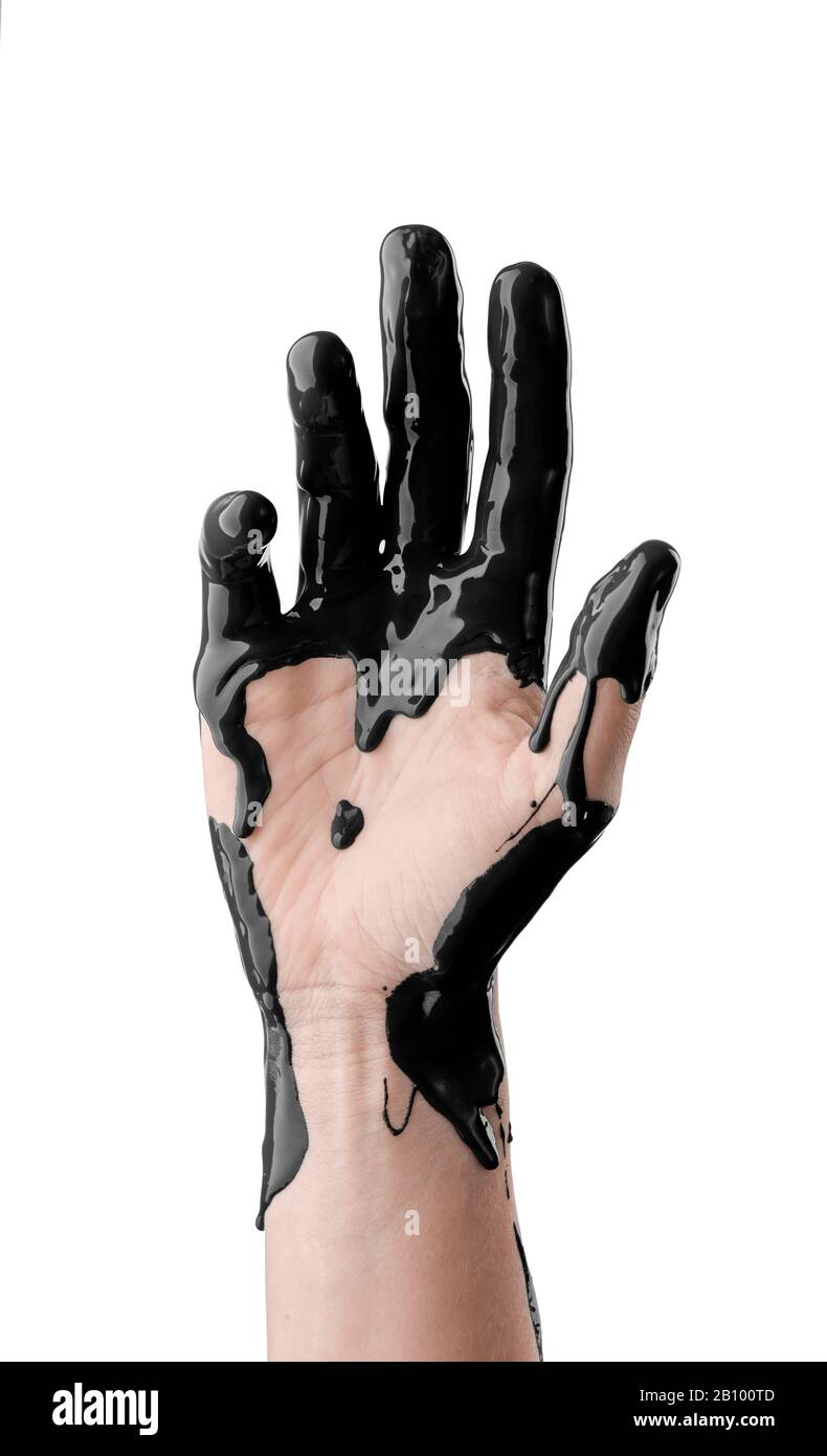 Female refined hand smeared with black and gold acrylic paint on a ...