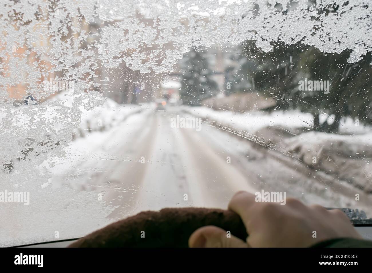 view of the fogged icy cold windshield of the car from the driver's ...