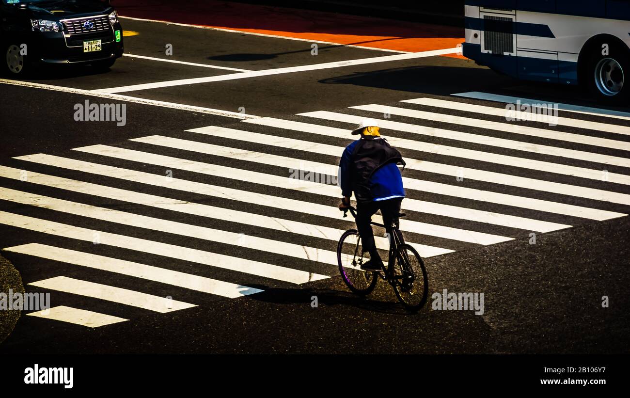 A Cycling in Tokyo speed across the pedestrian zebra crossing Stock ...