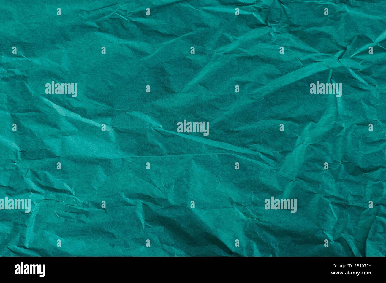 Green crumpled packing paper background close up view Stock Photo - Alamy