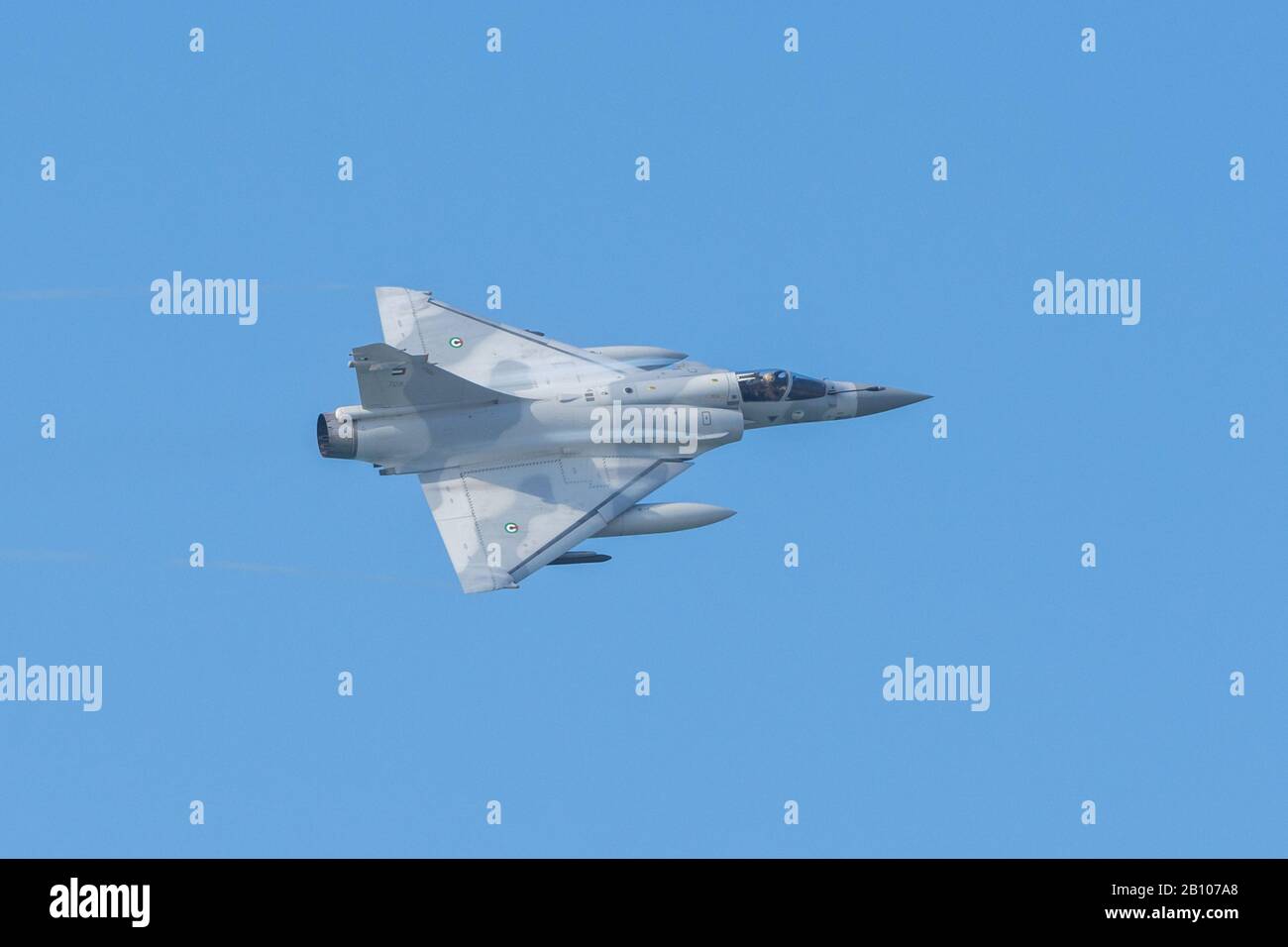 Military fighter jet flying fast through the air in coordination with ...