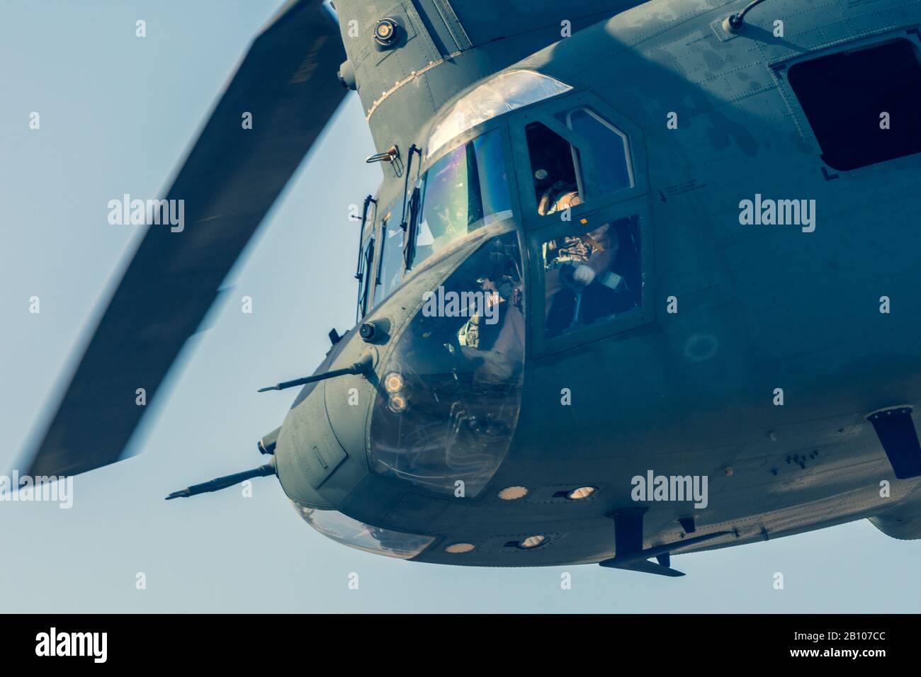 Military combat and war with Chinook helicopter close up flying through ...