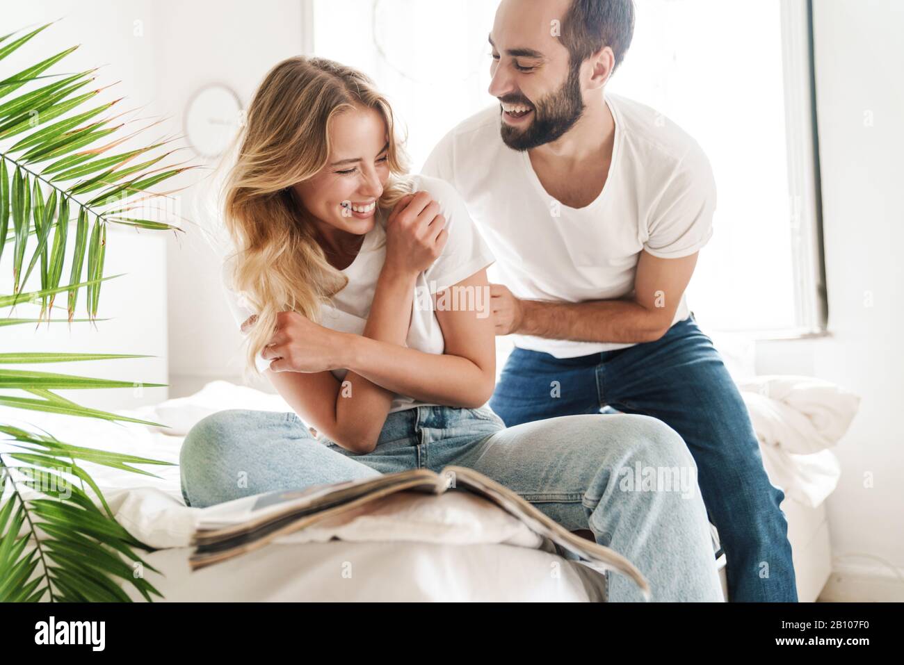 Happy young couple in love relaxing on a couch at the living room ...