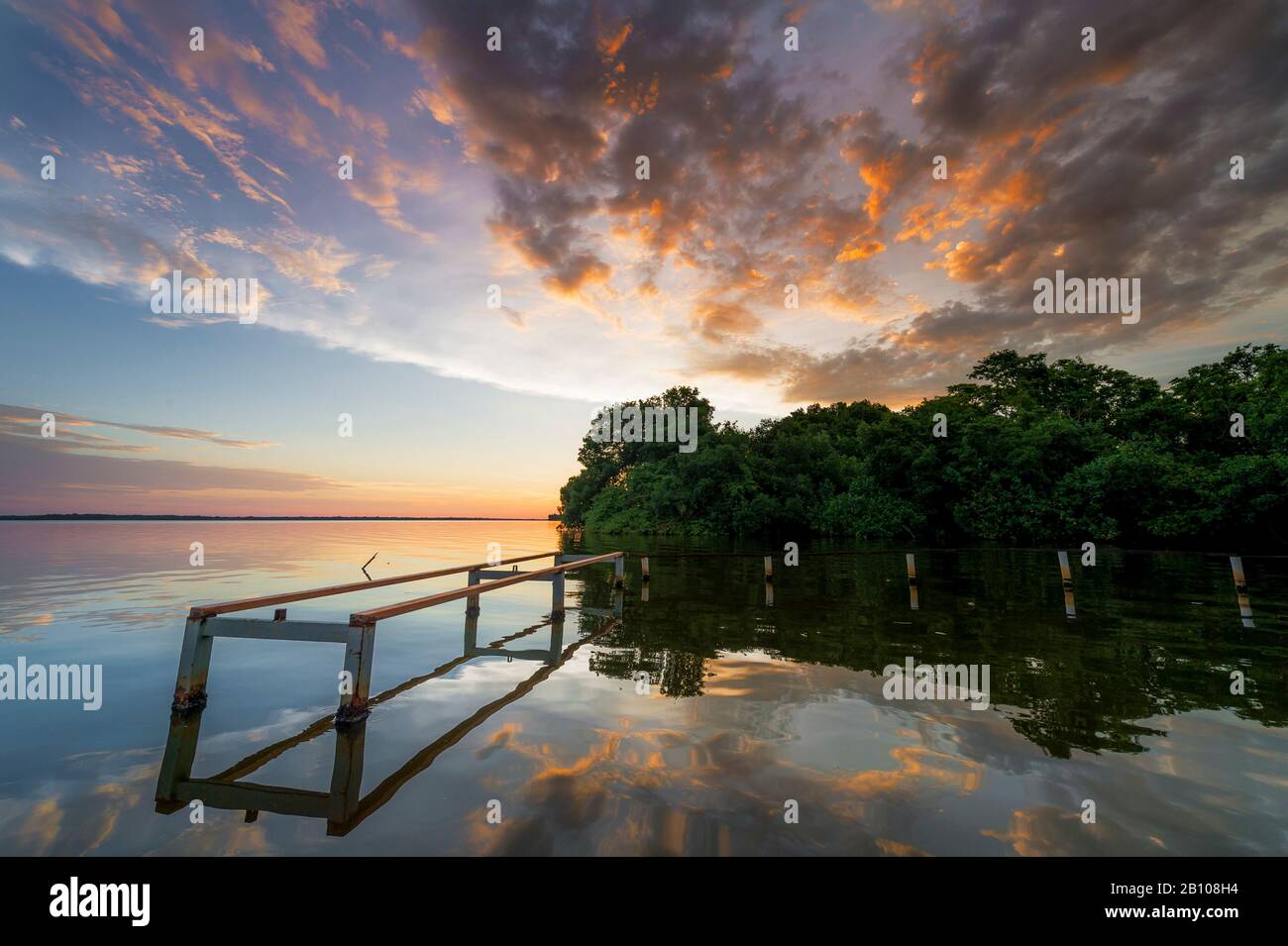 Colorful sunset under the ice screen of a large storm cell with ...
