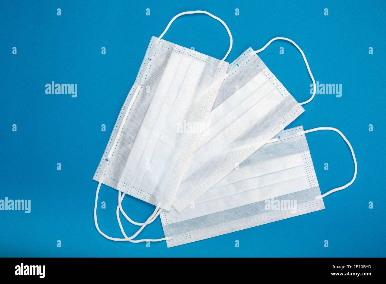 Three surgical masks with rubber ear straps. Typical 3-ply surgical ...