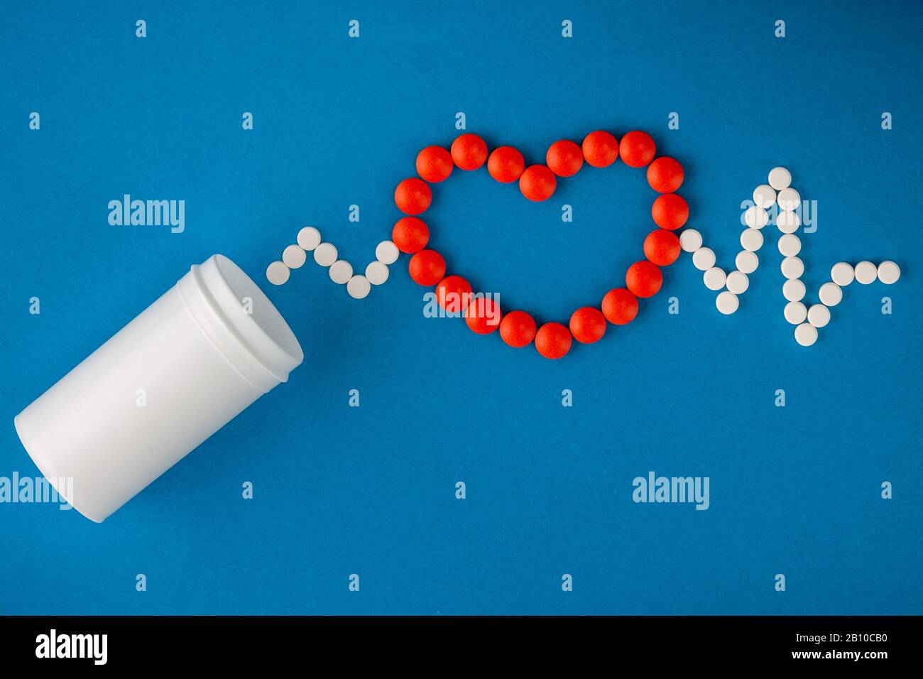 Heart health concept. Medication bottle and red pharmaceutical medicine ...