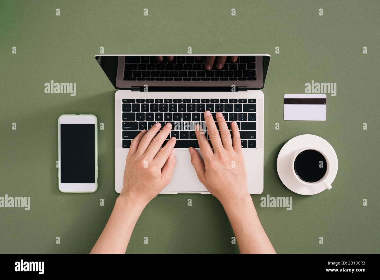 Human using laptop top view on minimal workspace. Color background and ...