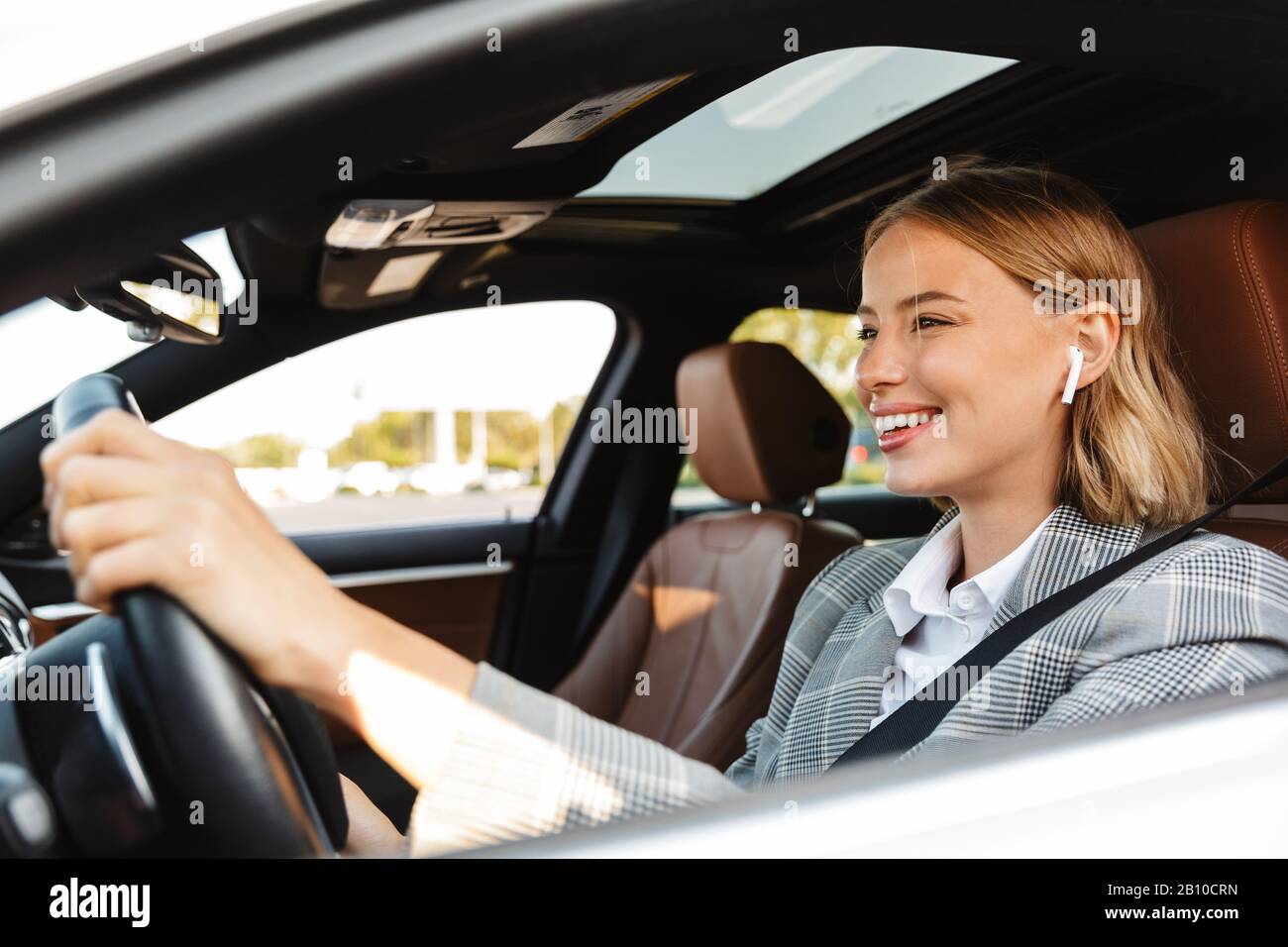 Image of young caucasian successful businesslike woman in formal wear ...