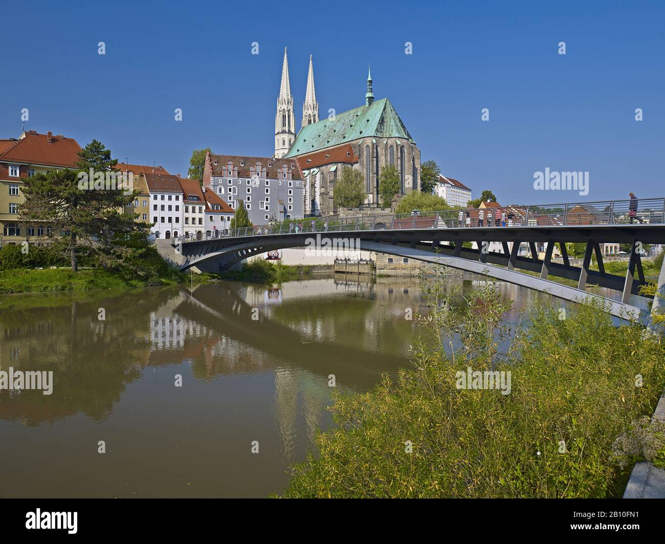 Bridge over the river Neisse to the old town with church St. Peter and ...