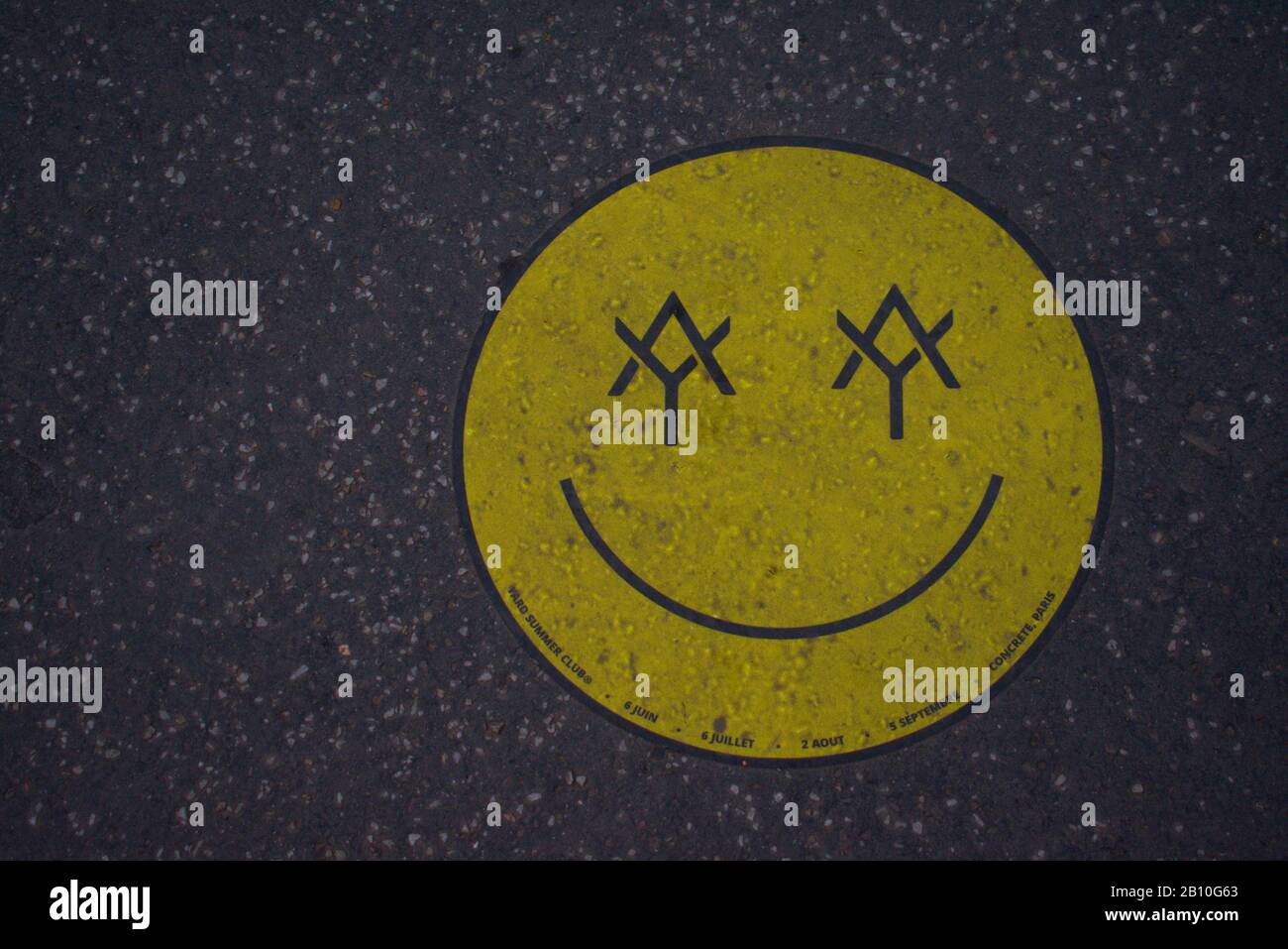 Smiley face in the asphalt in Paris Stock Photo - Alamy