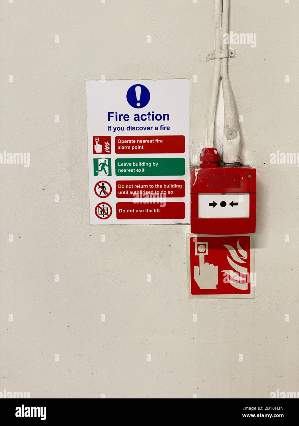 Fire action plan sign and manual fire alarm point in public work place ...