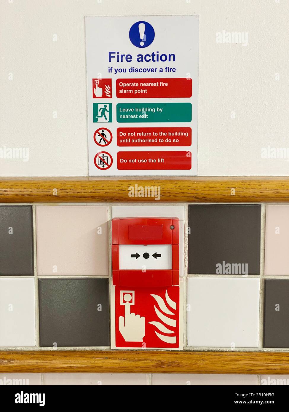 Fire action plan sign and manual fire alarm point in public work place ...