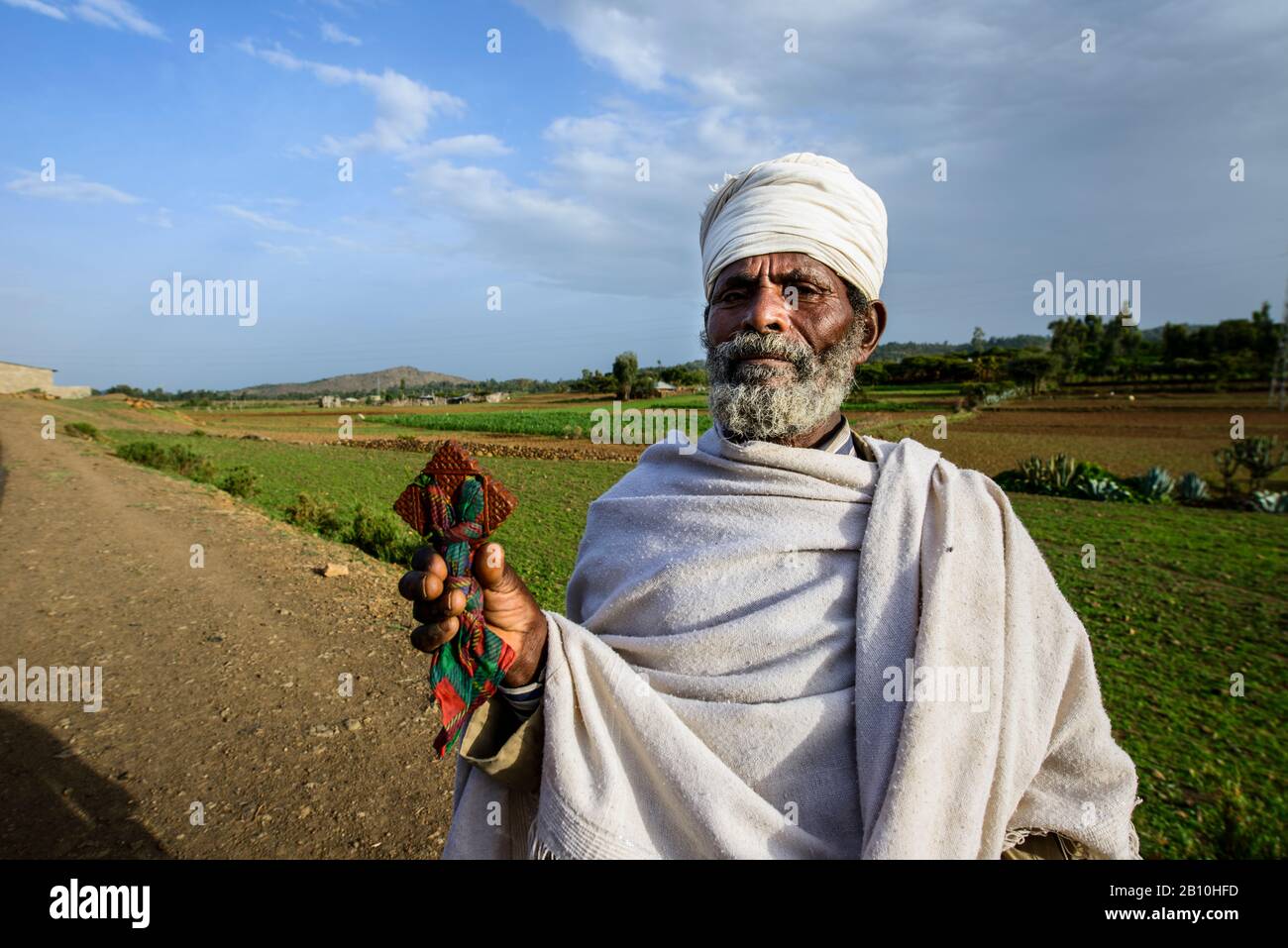 Priest of the Ethiopian Orthodox Church shows the typical crucifix ...